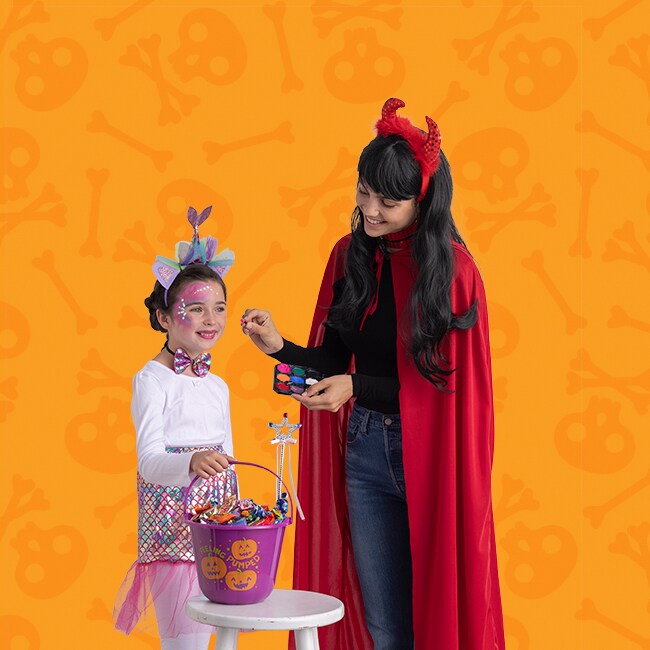 Two kids dressed in Halloween costumes getting ready to go trick-or ...